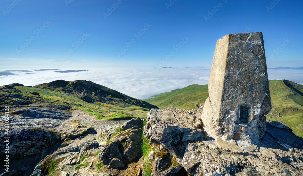 The trig point marker on the mountain summit of Ben Lawers looking out ...