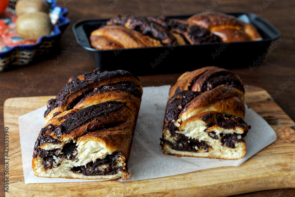 Braided cake with chocolate cut in half. Yeast-risen dough twisted krantz cake. Stock Photo ...