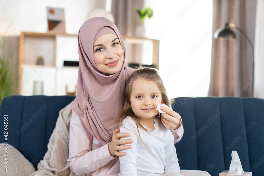 Happy Arabian family, muslim mom and her little cute daughter, sitting ...