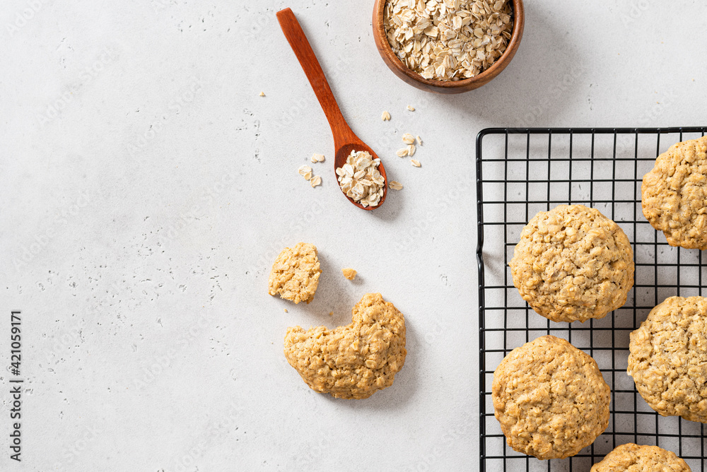 Homemade oatmeal cookies with banana, oats and nuts on a grid and oats ...