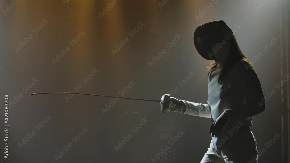 Swordsman woman training with rapier. Female athlete in white uniform ...