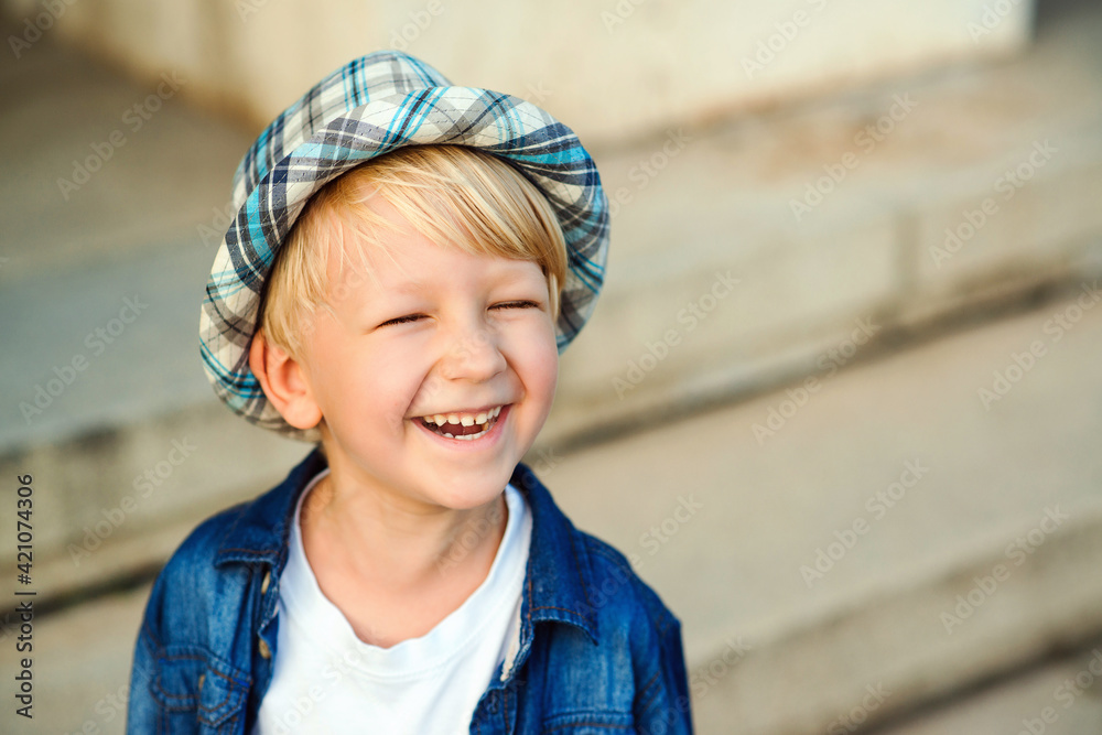 Happy child showing front teeth with big smile. Funny boy on a walk ...