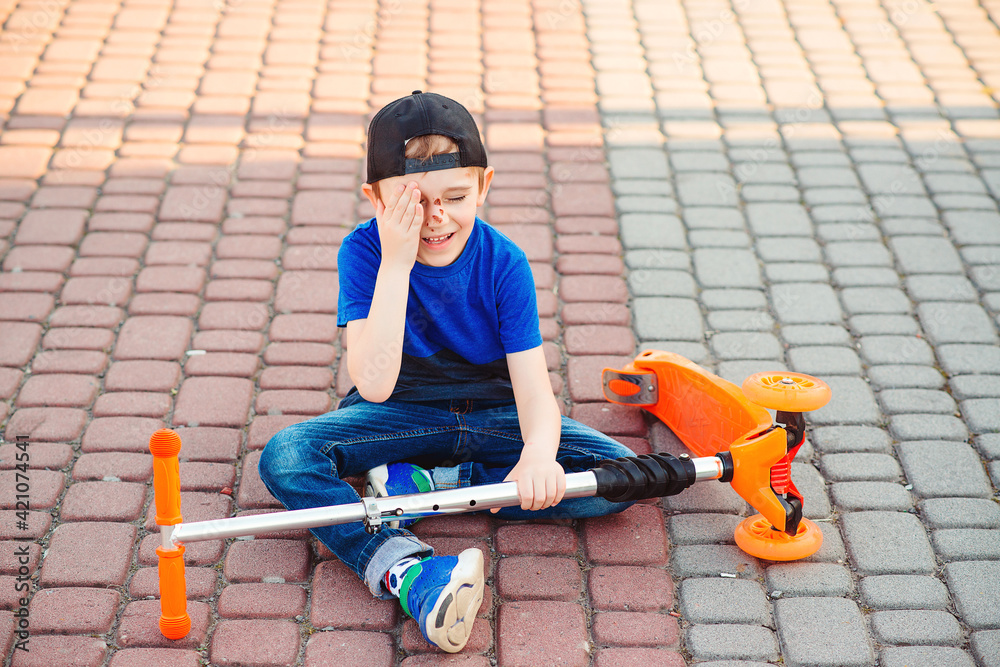 Boy falling off his scooter. Kid getting hurt while riding a kick ...