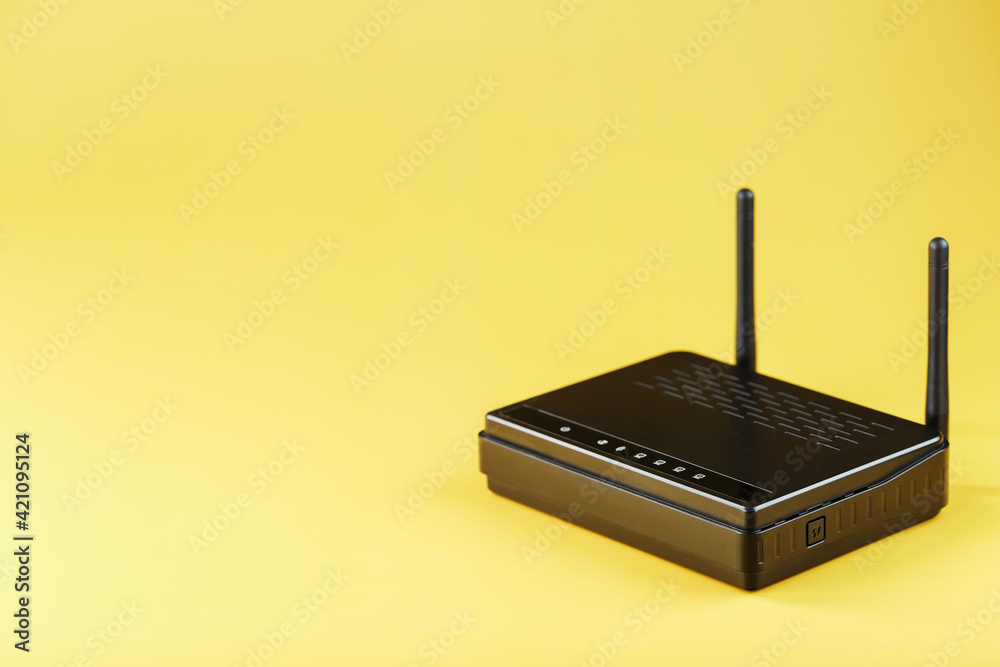 Wi-Fi router in black on a yellow background with free space. Stock ...