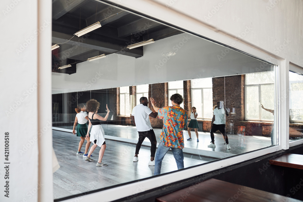 Sporty young team dancing together before mirror Stock Photo | Adobe Stock