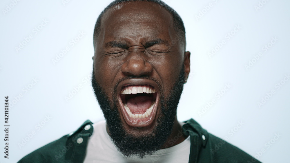Shocked african american man screaming in light background. Afro guy ...