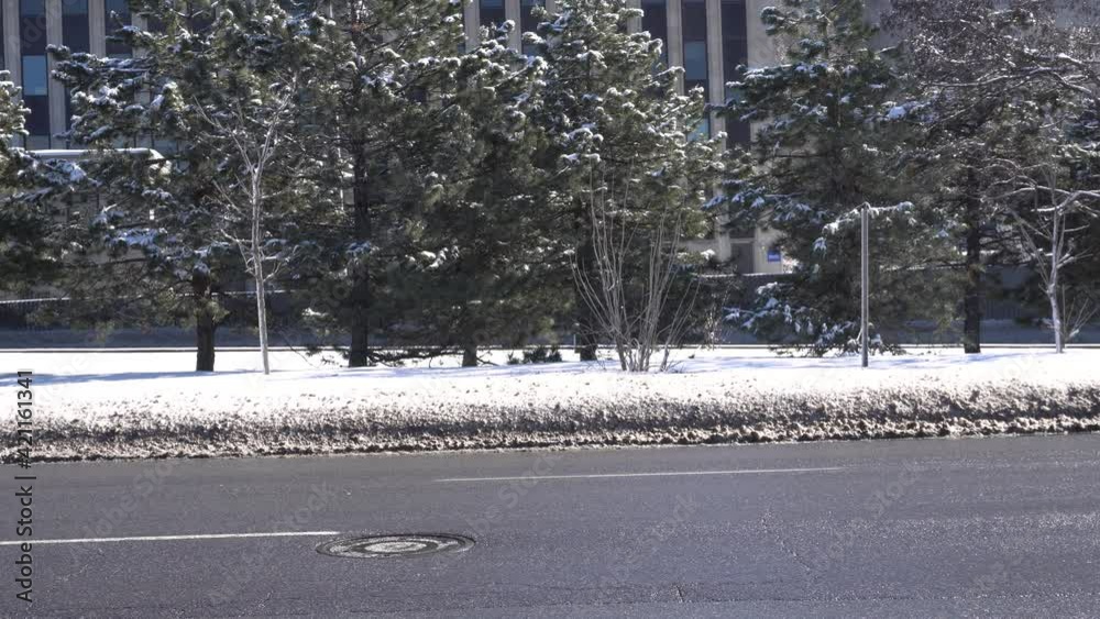 Cars are passing both sides of a busy street. In the middle, you can ...