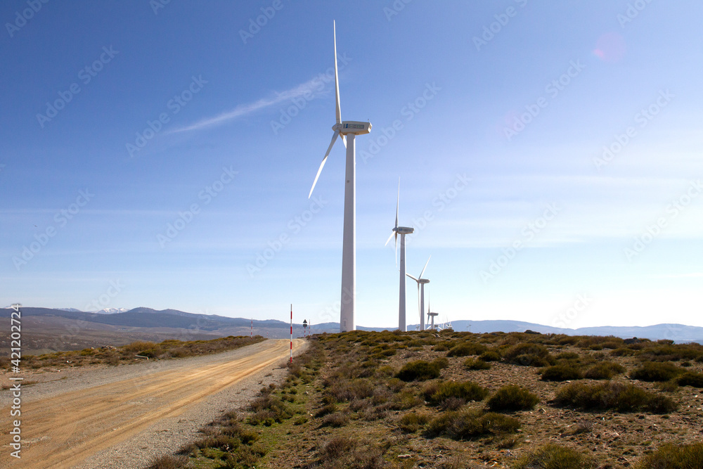 Clean electricity producing wind turbines built on a windy mountain ...