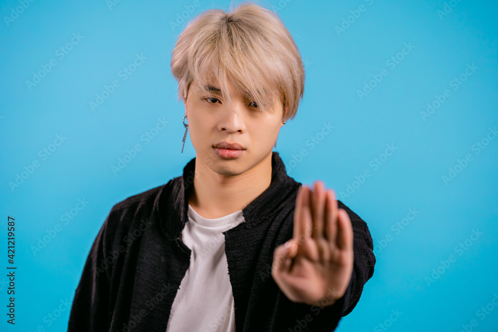 Asian man disapproving with NO hand sign gesture. Denying, rejecting ...
