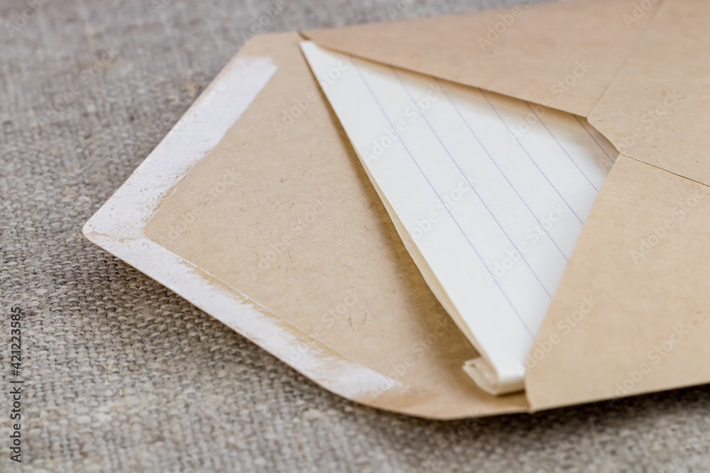 lined sheet of paper (a letter without text) lies in an open craft ...