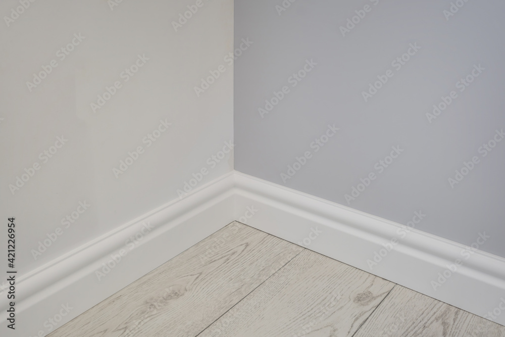 Detail of corner flooring with intricate crown molding and plinth ...