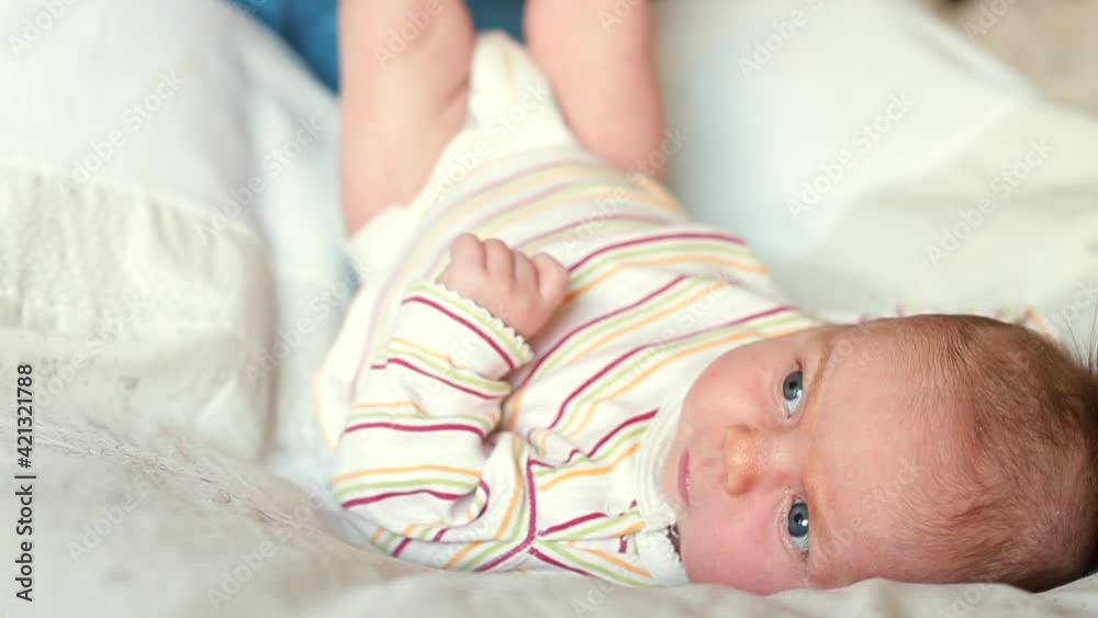 Portrait of a toddler. Mechanical stimulation of the child's legs on ...