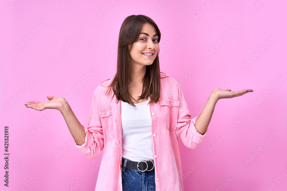 Young woman makes a decision with a happy smile, chooses between two ... Young woman makes a decision with a happy smile, chooses between two ...