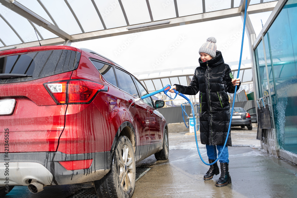 washing car at autowash . Car wash. red machine under the pressure of ...