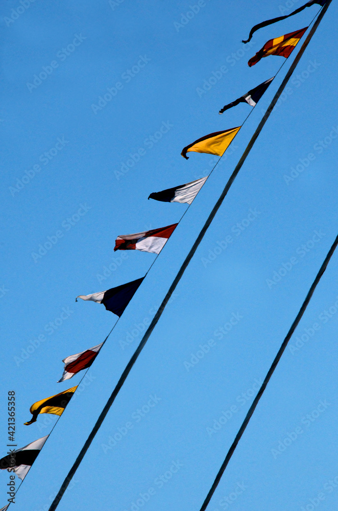 Nautical signal flags on lines off ships mast Stock Photo | Adobe Stock