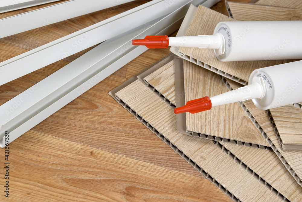 Set of items for PVC ceiling indoor works. Assembly adhesive bottles ...