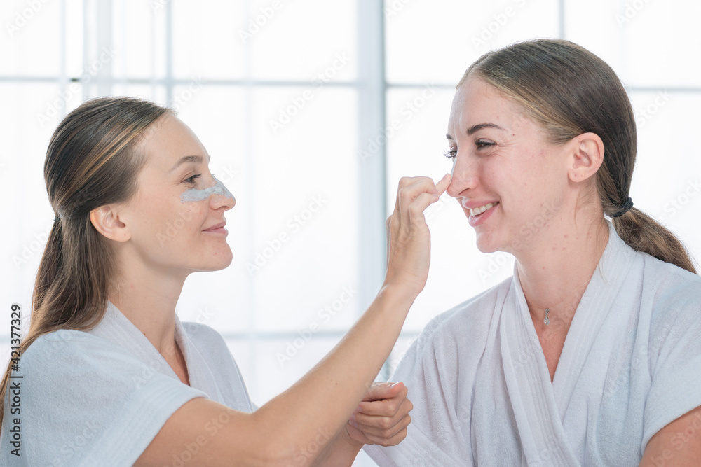 natural portrait two women face with Smiling young female lathering ...