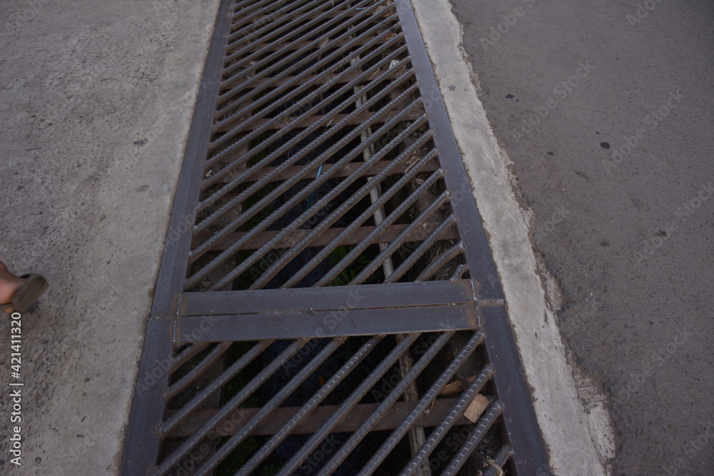 Grate iron or metal. drains on the roads in every city. The water goes ...