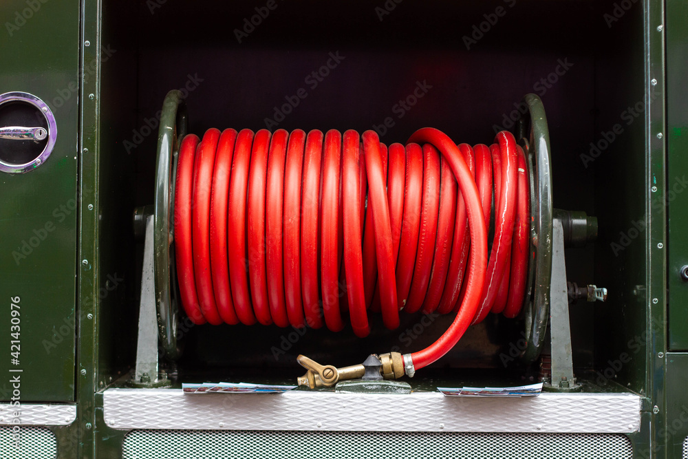 Coiled Or Rolled Red Rubber Fire Hose Seen On An Old Green Goddess ...