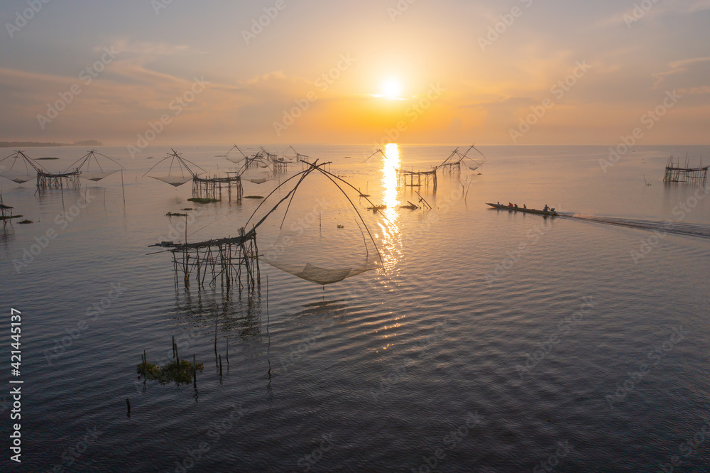 Local fishing trap net in canel, lake or river at sunset. Nature ...