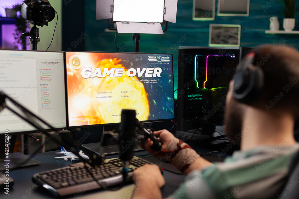 Back view of upseted streamer playing game competition using ...