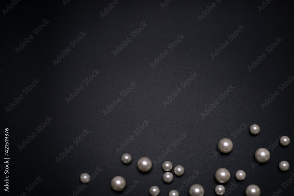 Pearls on the black background, with free space for text. Top view ...