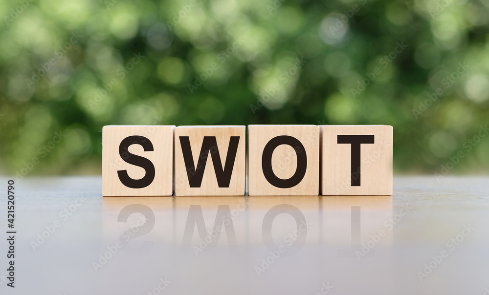 SWOT word written on wooden blocks. The text is written in black ...