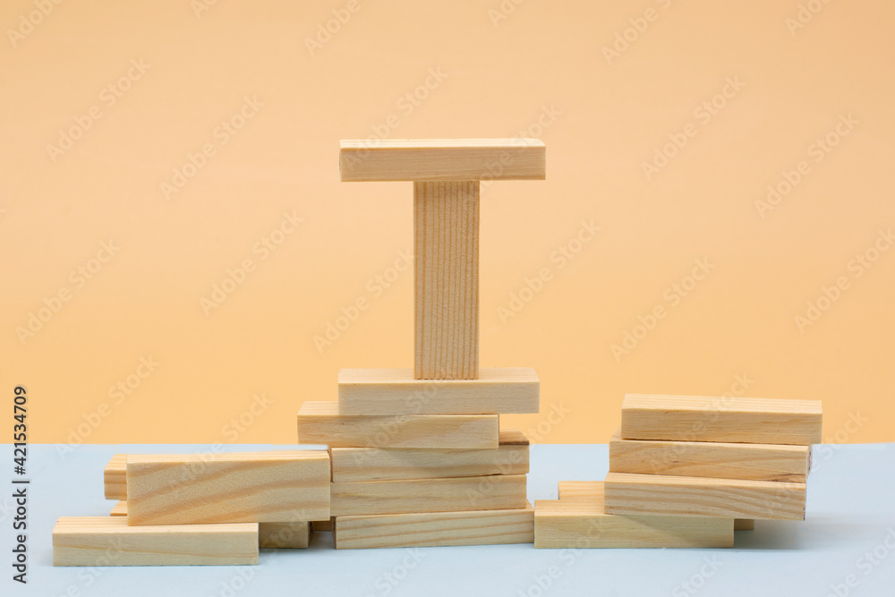 Fallen wooden blocks and one block standing. The concept of business ...