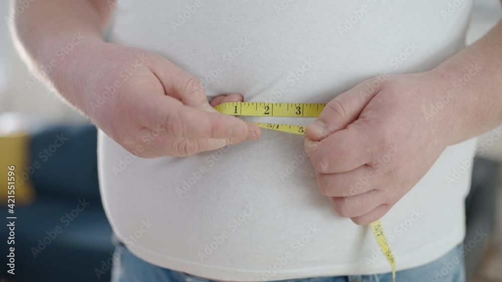 Plus size male measuring waist, using tape, body weight control, belly ...
