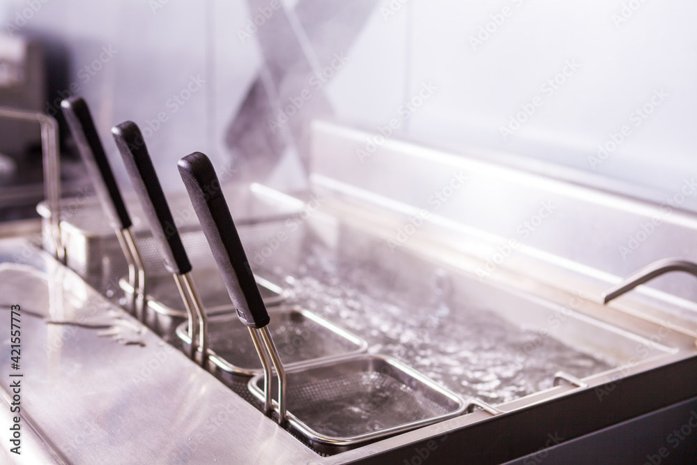 Boiling handmade pasta. Italian spaghetti boiling. Clean kitchen ...