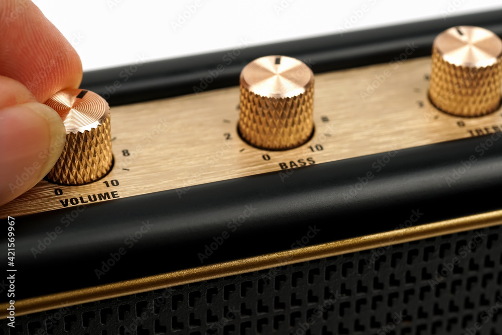 Hand adjusting volume control. Use hand to adjust the volume at the ...