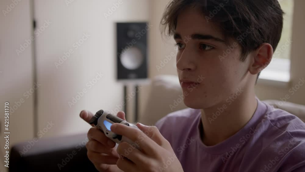 Beautiful Excited Young Gamer man Sitting on a Couch, Playing and ...