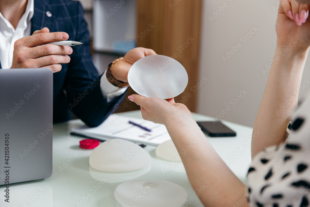 Cosmetic Surgeon Shows Female Patient Breast Implant Samples and Talk ...