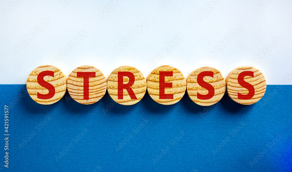 Stop stress and be health symbol. Wooden circles with the word 'stress ...