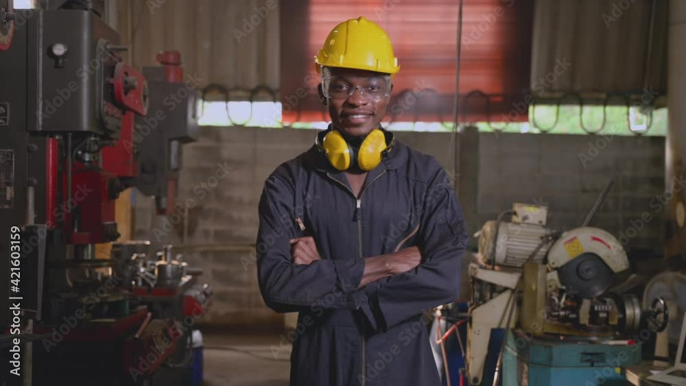 Portrait of african american workman in uniform and wearing safety ...