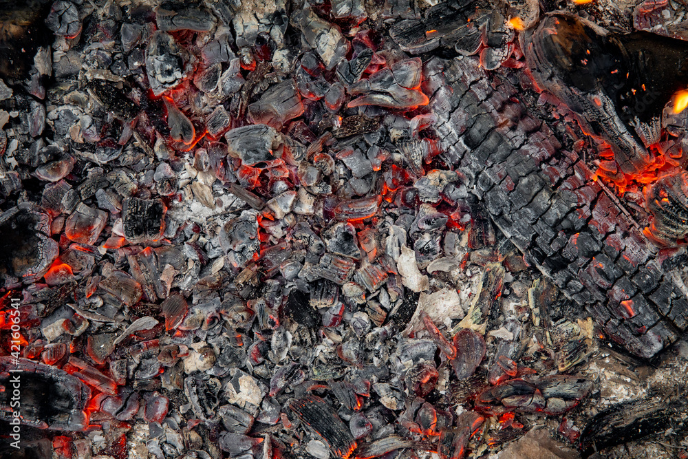 Glowing embers in hot red color, abstract background. The hot embers of ...