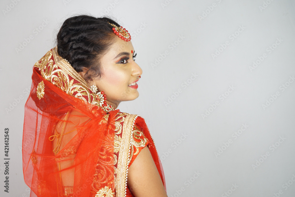 Gorgeous Indian bride with heavy makeup wearing traditional Indian ...