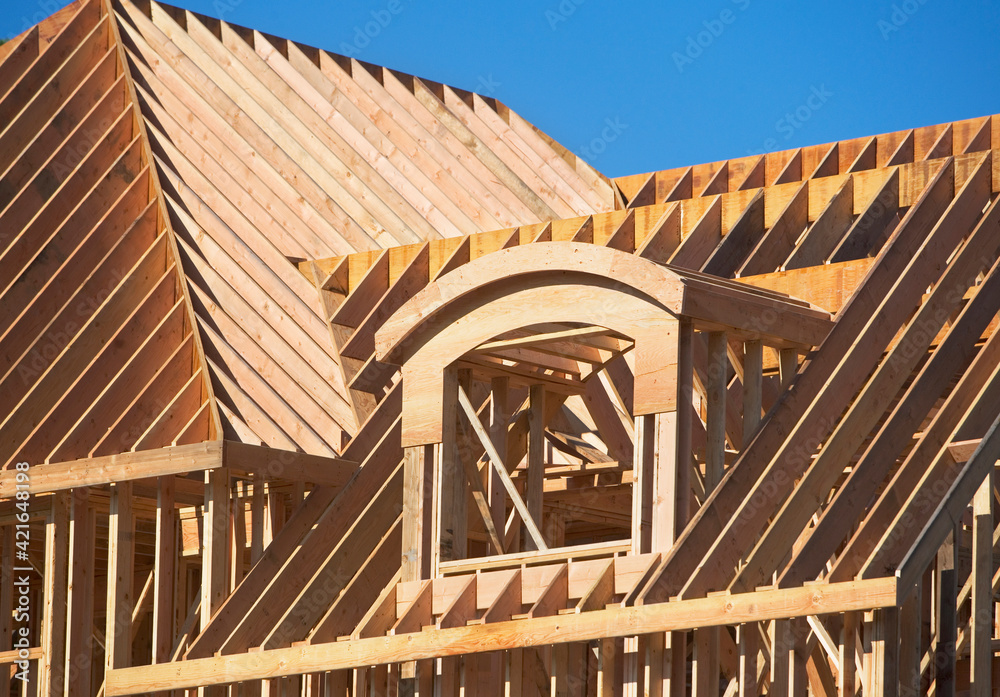 Roof framing of partially built house Stock Photo | Adobe Stock