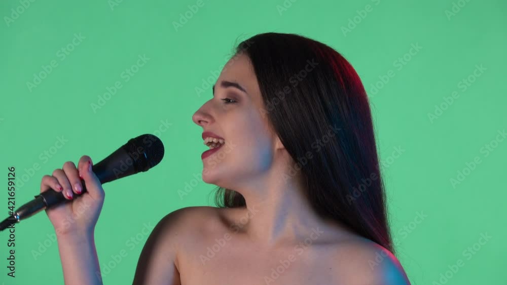 Portrait of beautiful young woman illuminated by blue red neon light ...