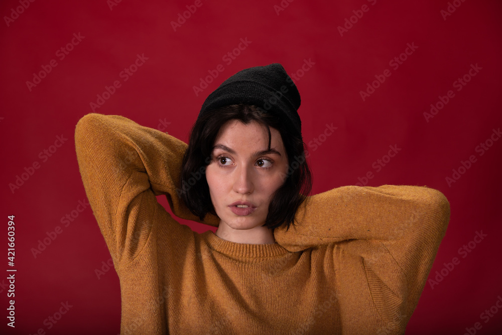 brunette hipster girl in black knitted cap and mustard sweater posing ...
