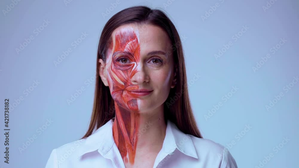 Young woman with half of face with muscles structure under skin. Model ...