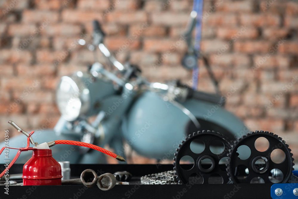 Motorcycle repairing service concept background. An old gear wheels ...