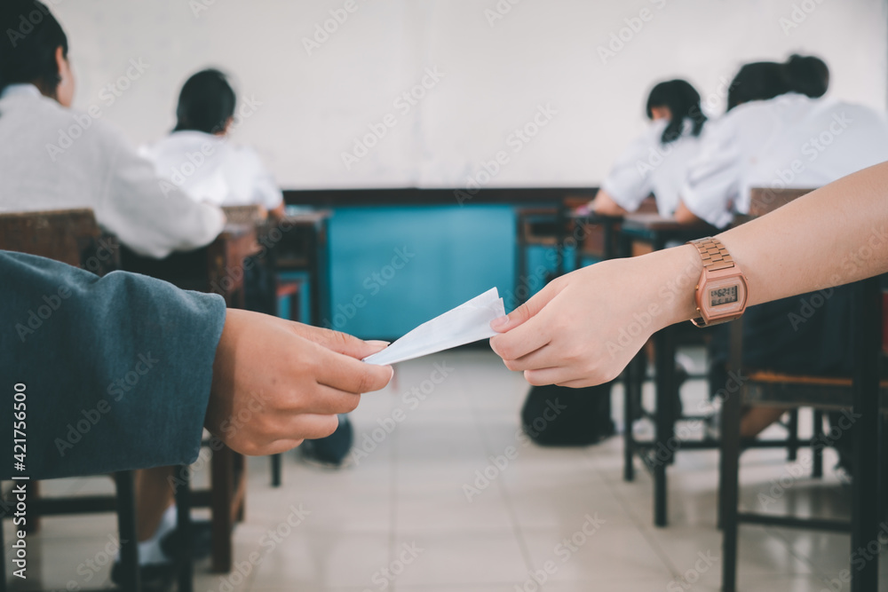 Students passing notes to each other secretly during class Stock Photo ...