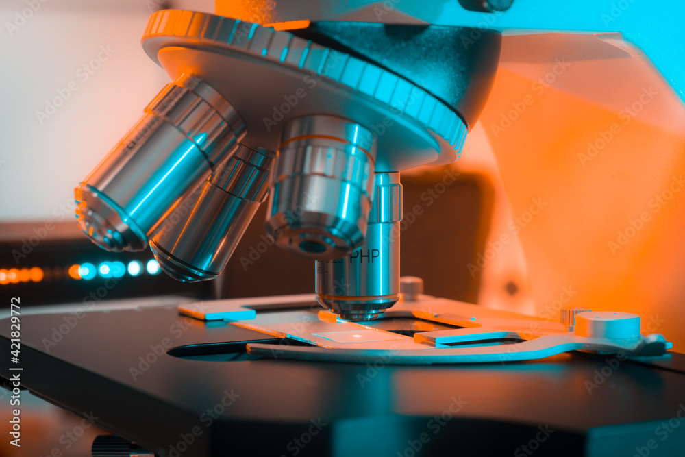Toned photo of a backlit microscope lens in a science laboratory Stock ...