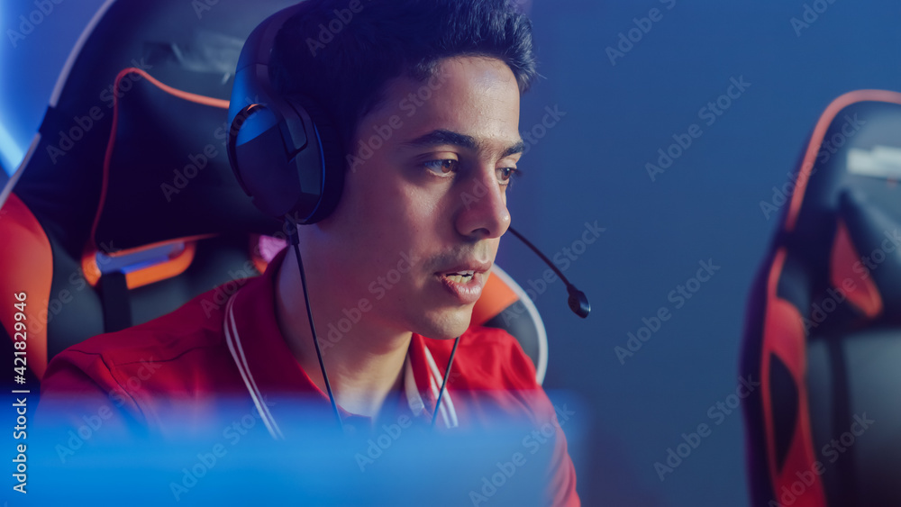 Professional Gamer Plays Computer Video Game Talking into Headset with ...
