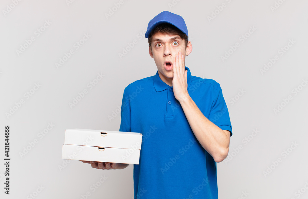 young pizza deliver boy feeling shocked and scared, looking terrified ...