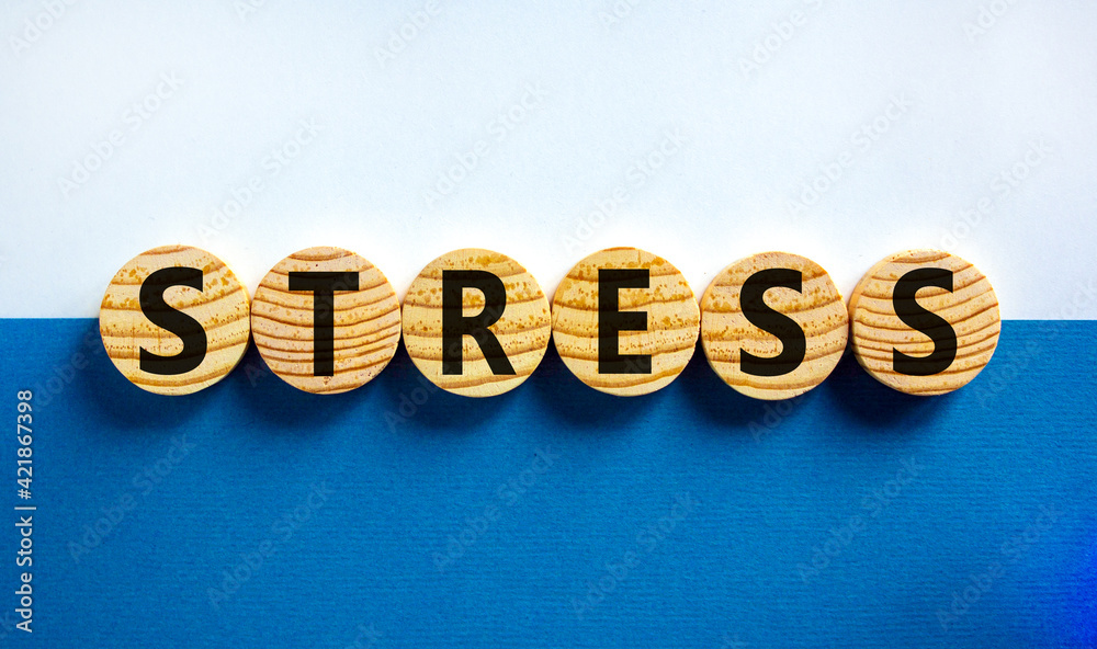 Stop stress and be health symbol. Wooden circles with the word 'stress ...