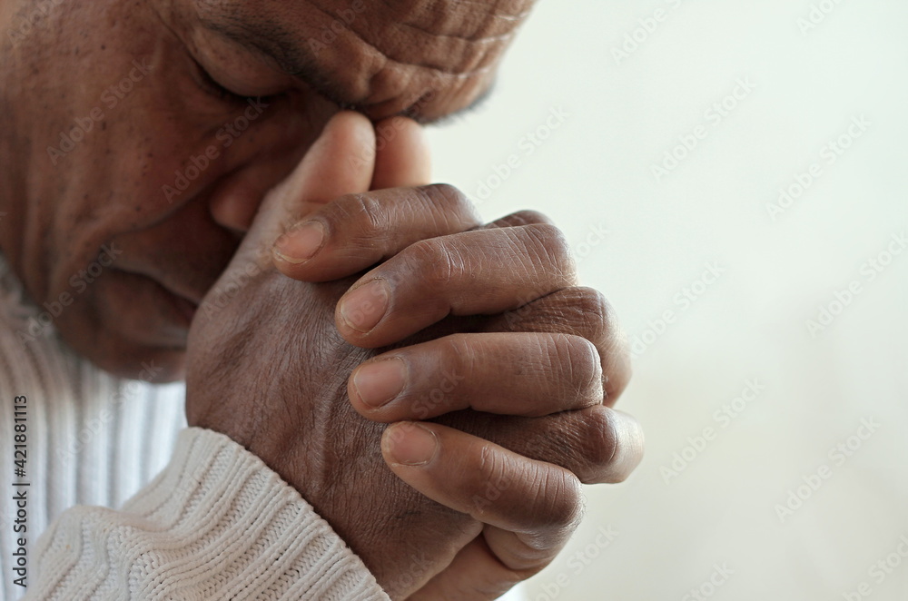 man praying to god with hands together Caribbean man praying with white ...