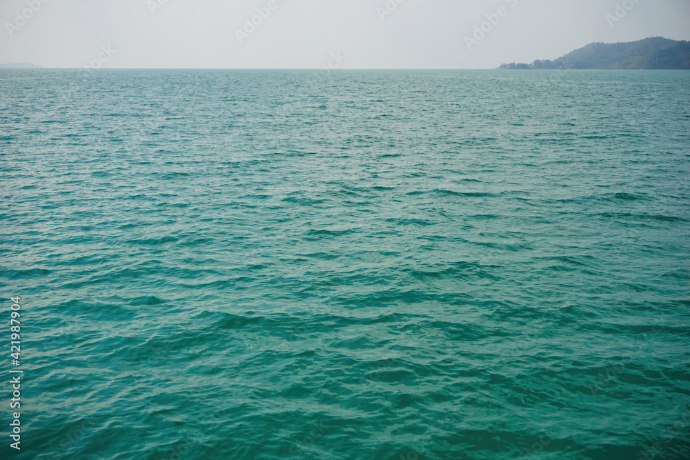 The surface of the water is calm in the middle of the sea. The sea is ...