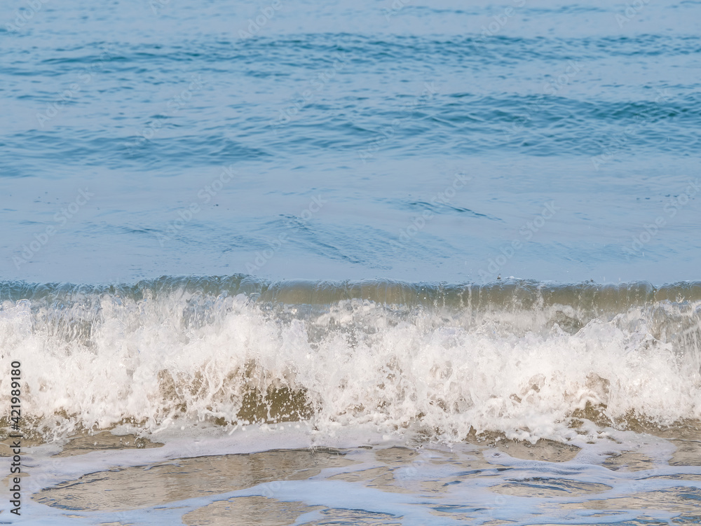 Small breaking waves with foam on the beach of the Black Sea. Stock ...